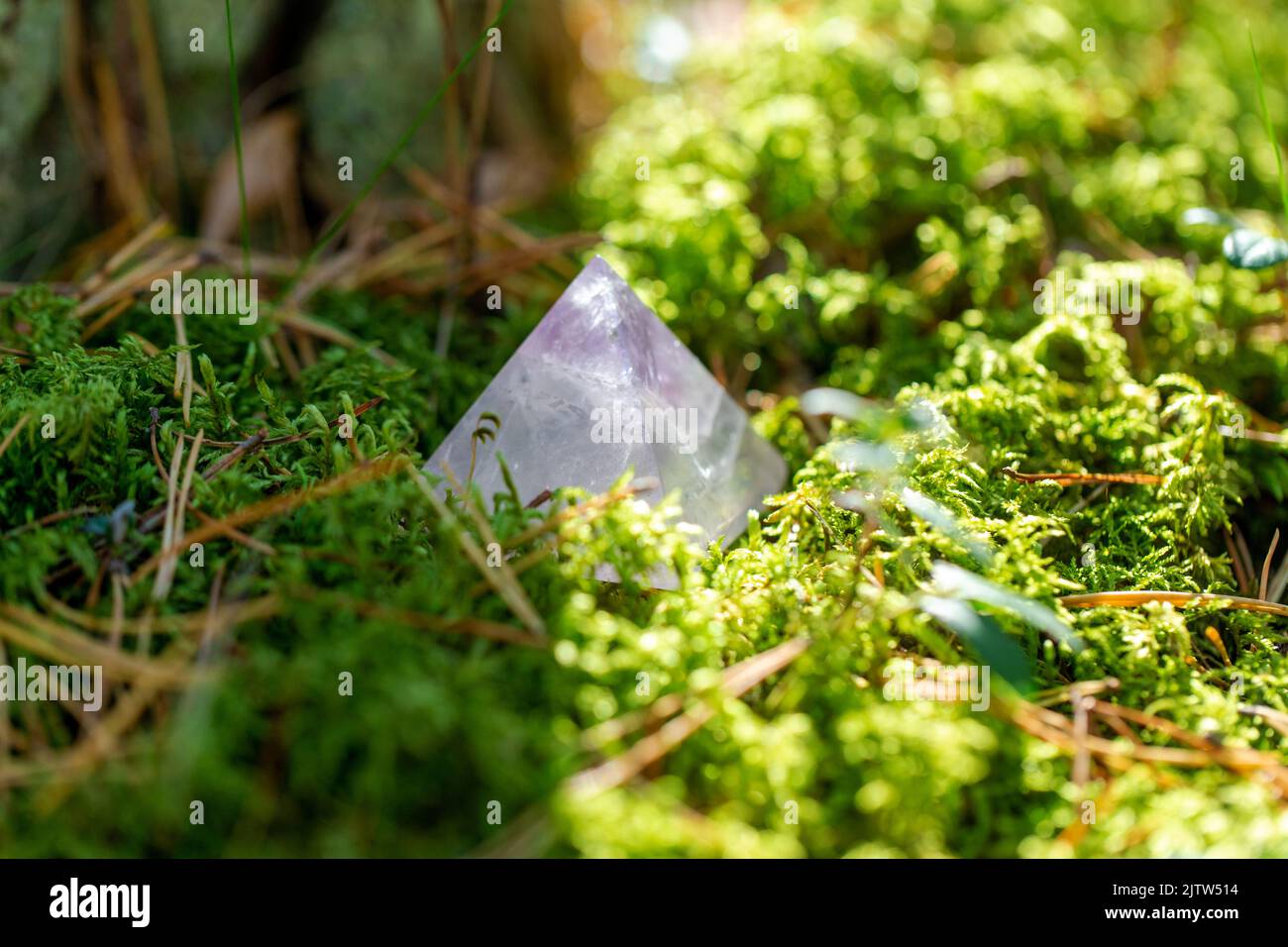 quartz crystal pyramid on moss in forest Stock Photo - Alamy