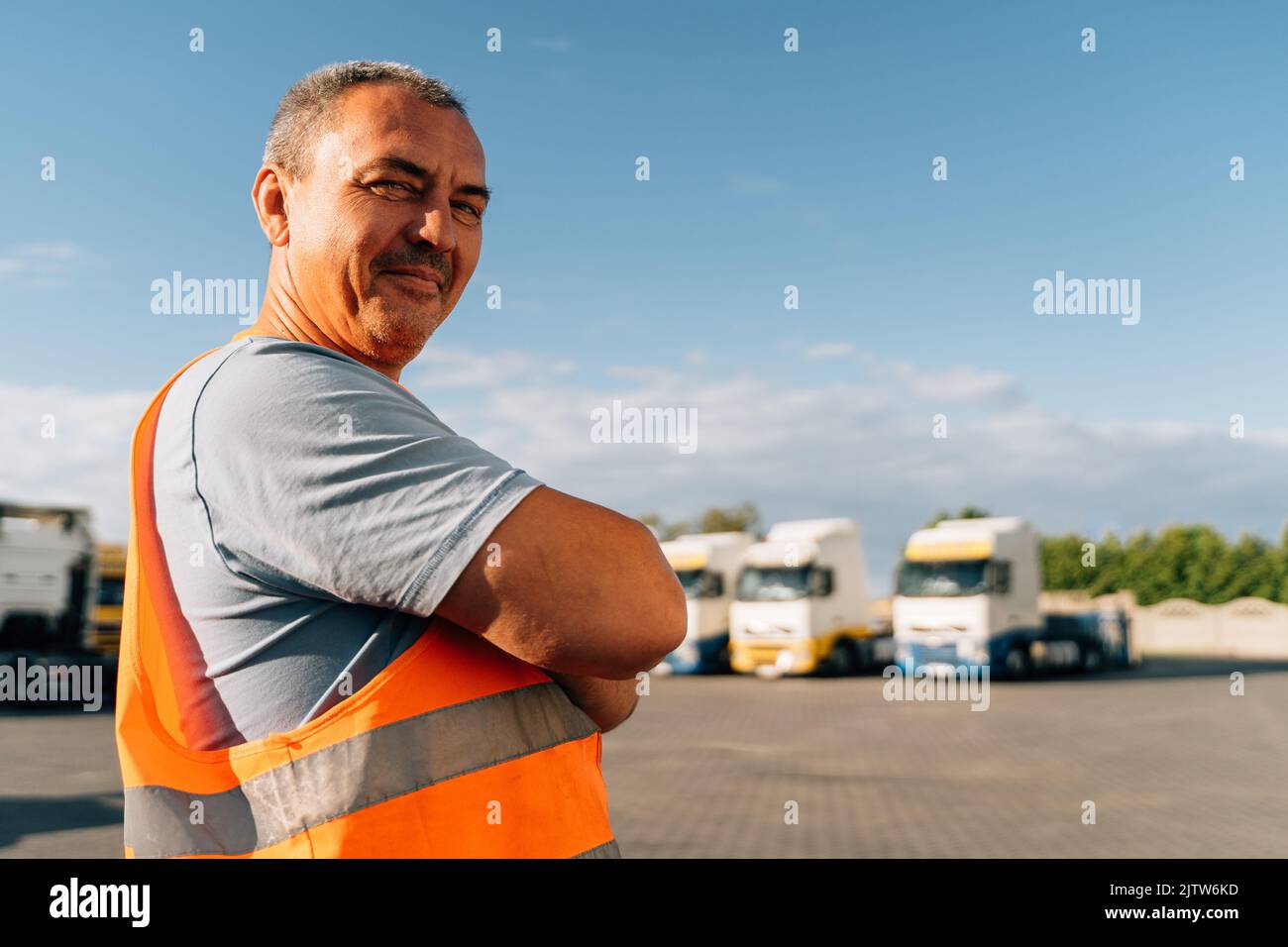 Portrait of caucasian mature man on semi-truck vehicles parking ...