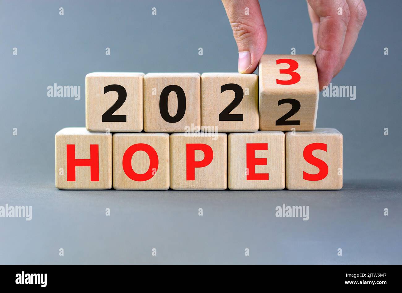 2023 hopes new year symbol. Businessman turns a wooden cube and changes ...