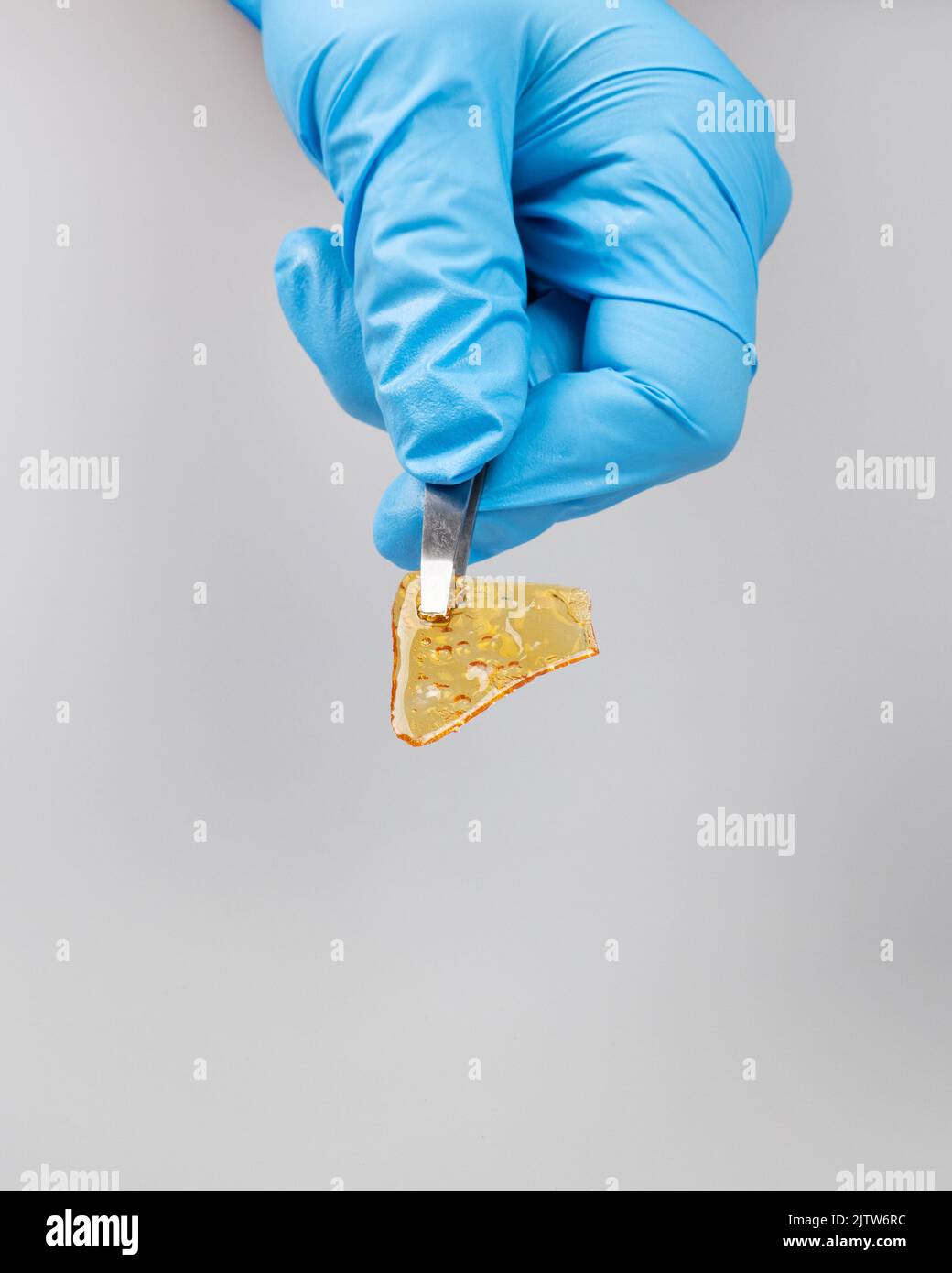 hand holding piece medical cannabis golden wax Stock Photo - Alamy