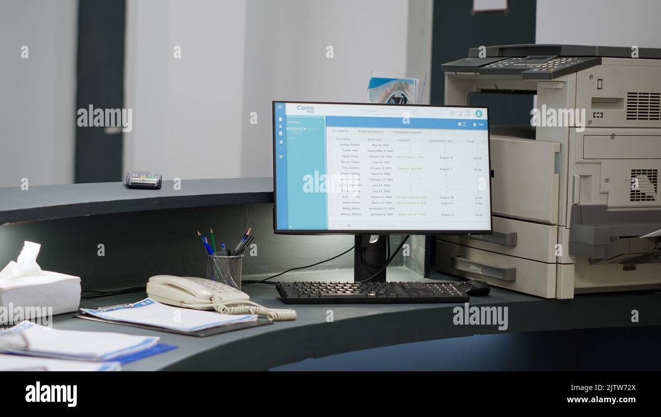 Hospital reception counter with computer desktop to help with medical ...