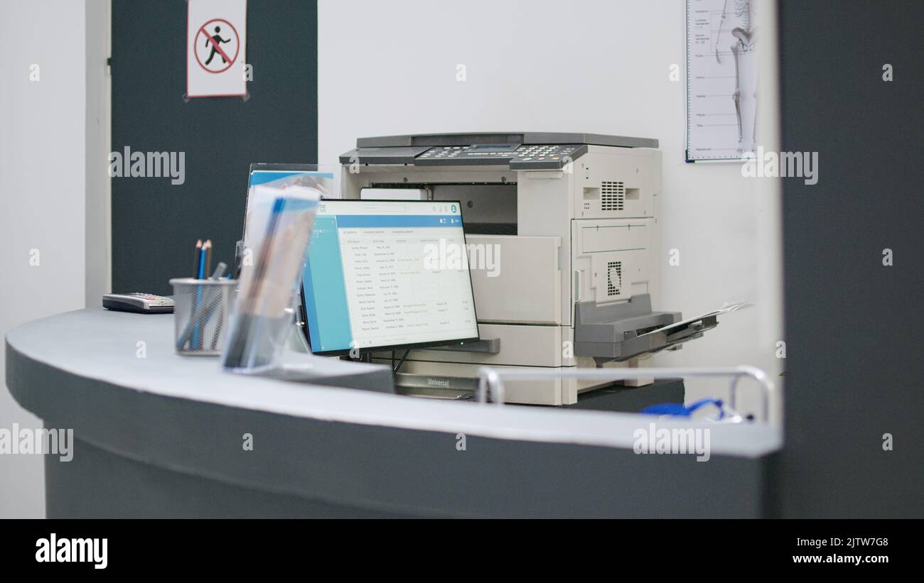Hospital reception counter with medical appointments on computer to ...