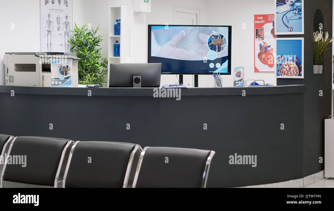 Waiting room lobby with empty reception counter desk to give help and ...