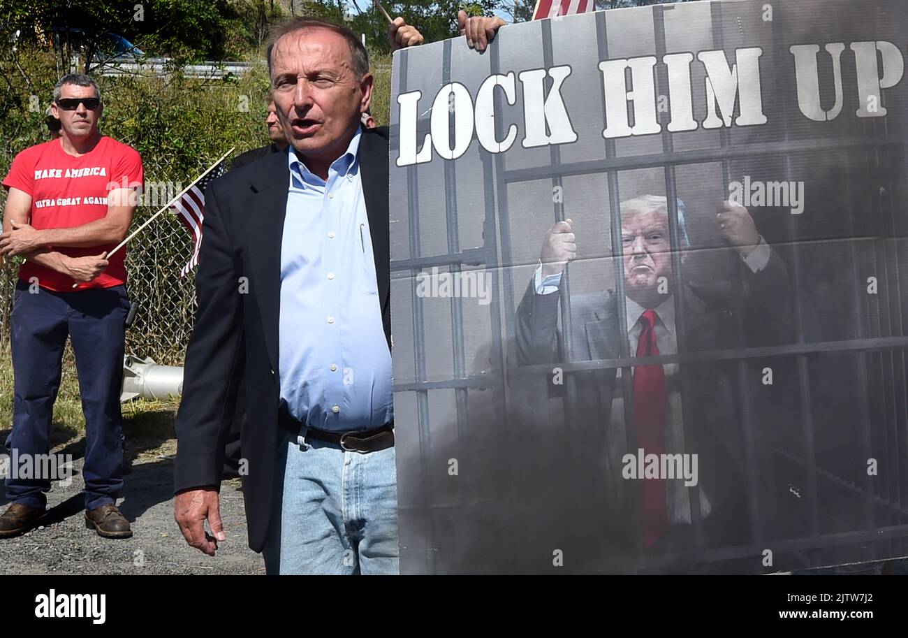 Gene Stilp holds a picture of Donald Trump behind bars over a barrel ...