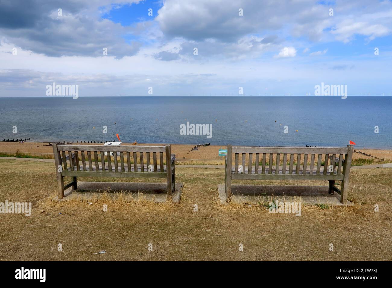 Two wooden park benches overlooking Tankerton Beach Stock Photo - Alamy