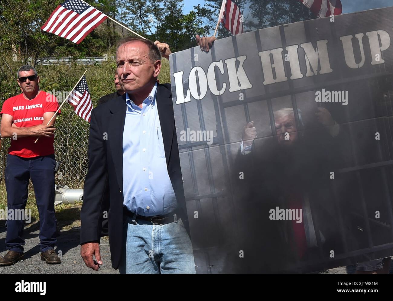 Gene Stilp holds a picture of Donald Trump behind bars over a barrel ...