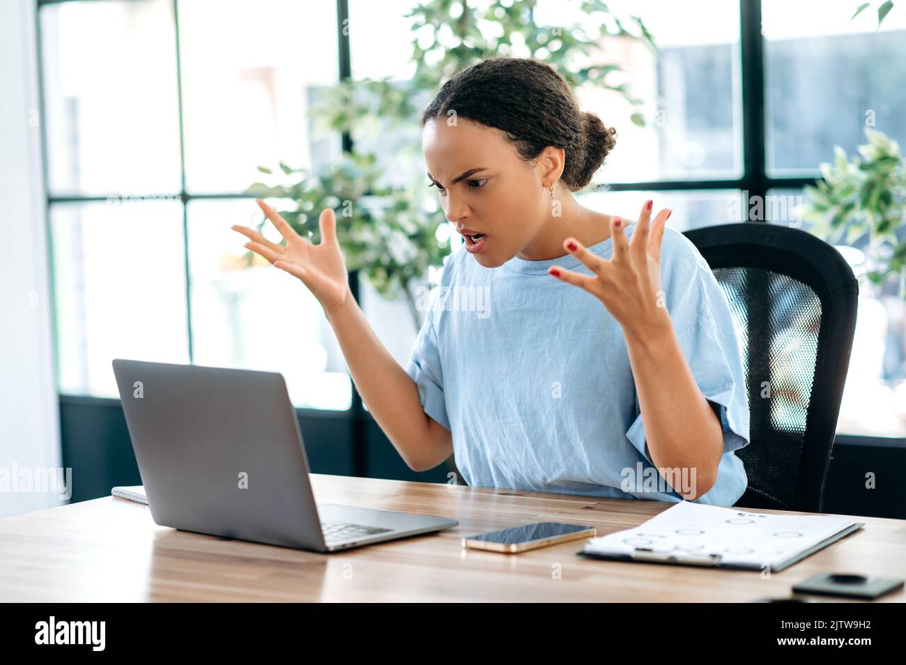 Irritated angry young mixed race business lady, company director ...