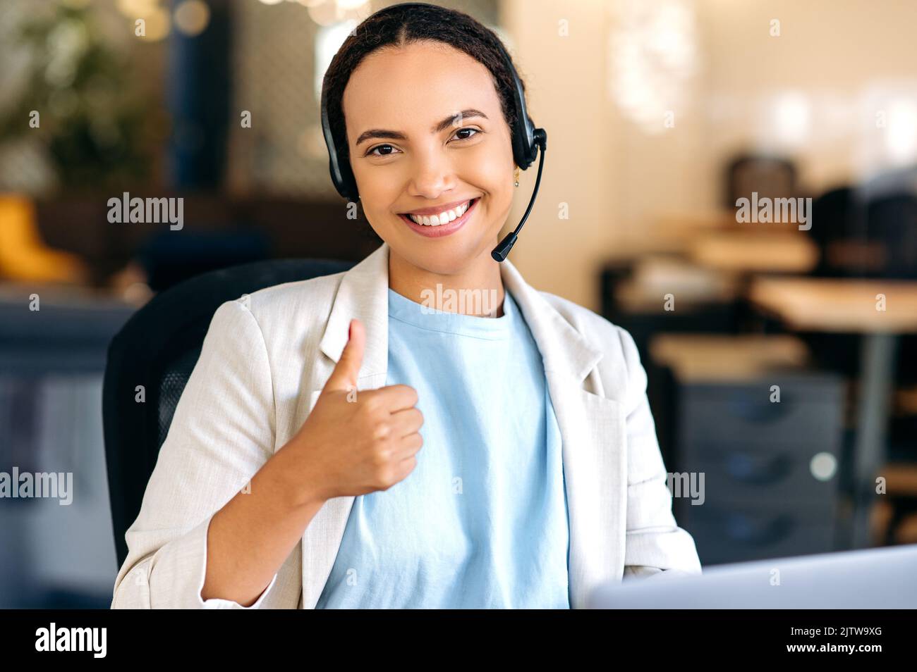 Woman in office shows thumb hi-res stock photography and images - Alamy