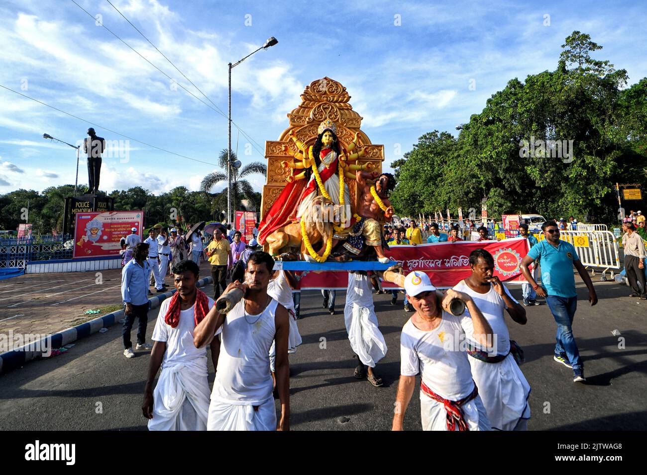 Performers seen carrying an idol of Devi Durga during the celebrations ...