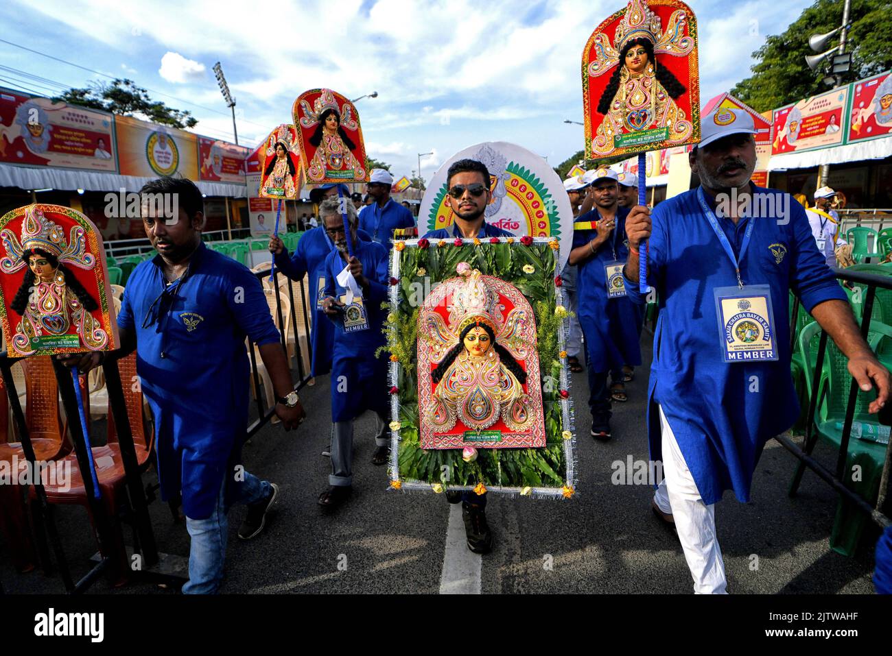 Performers hold a replica of Hindu God Devi Durga during the ...