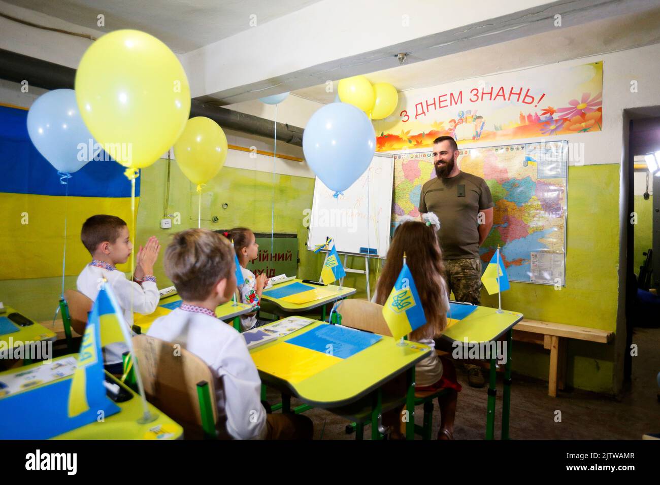 School children attending a class on the first day of school inside a ...