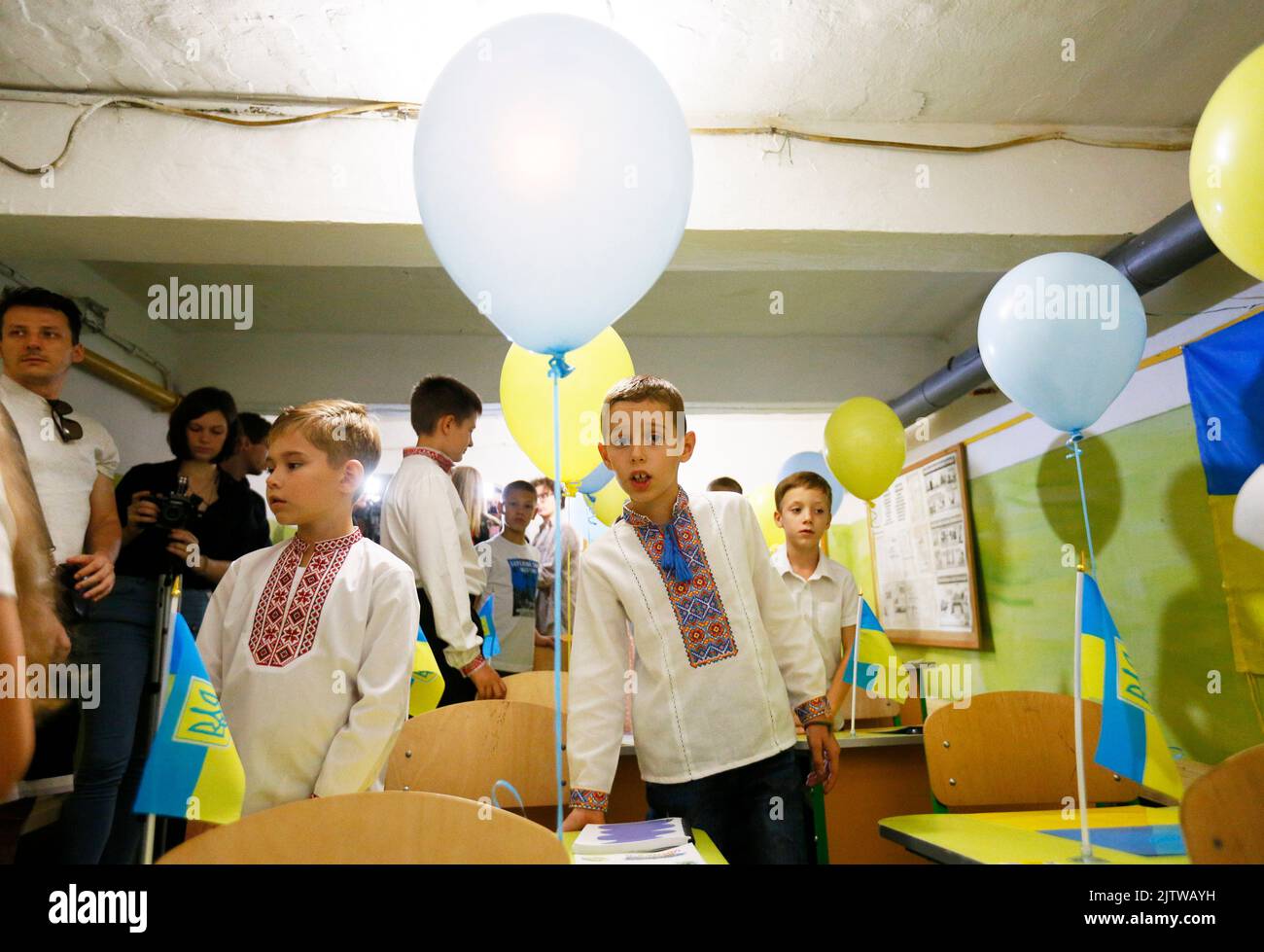 School children attending a class on the first day of school inside a ...