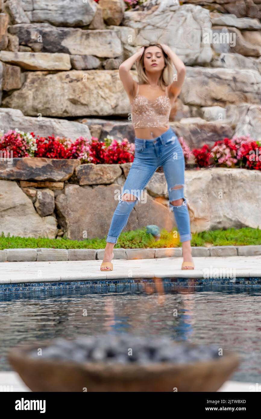 A gorgeous blonde model poses outdoors while enjoying the spring weather Stock Photo - Alamy