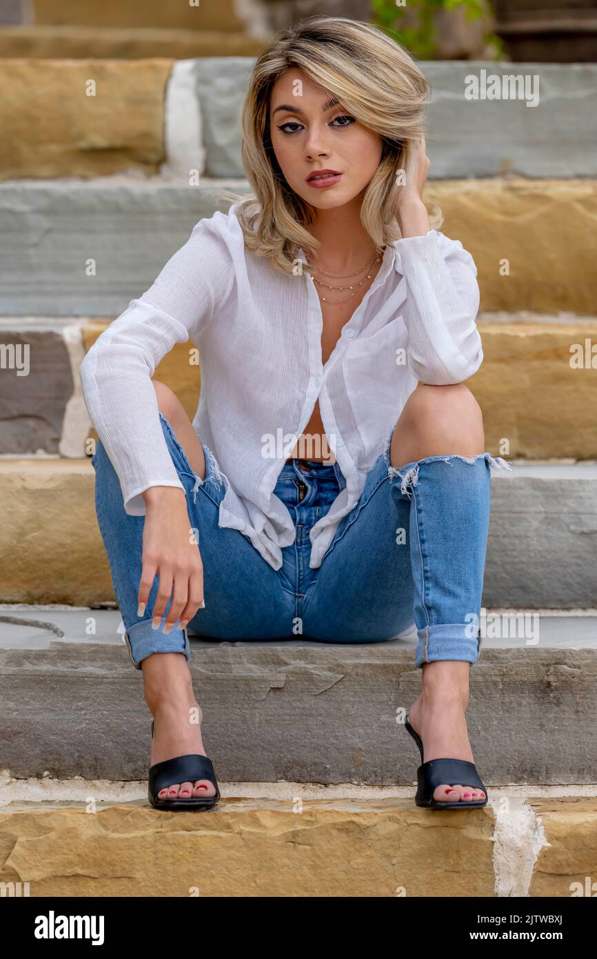 A gorgeous blonde model poses outdoors while enjoying the spring weather Stock Photo - Alamy
