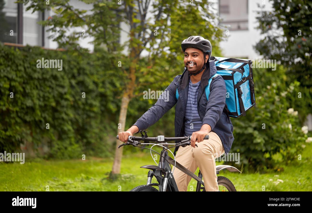 food delivery man with bag riding bicycle Stock Photo - Alamy