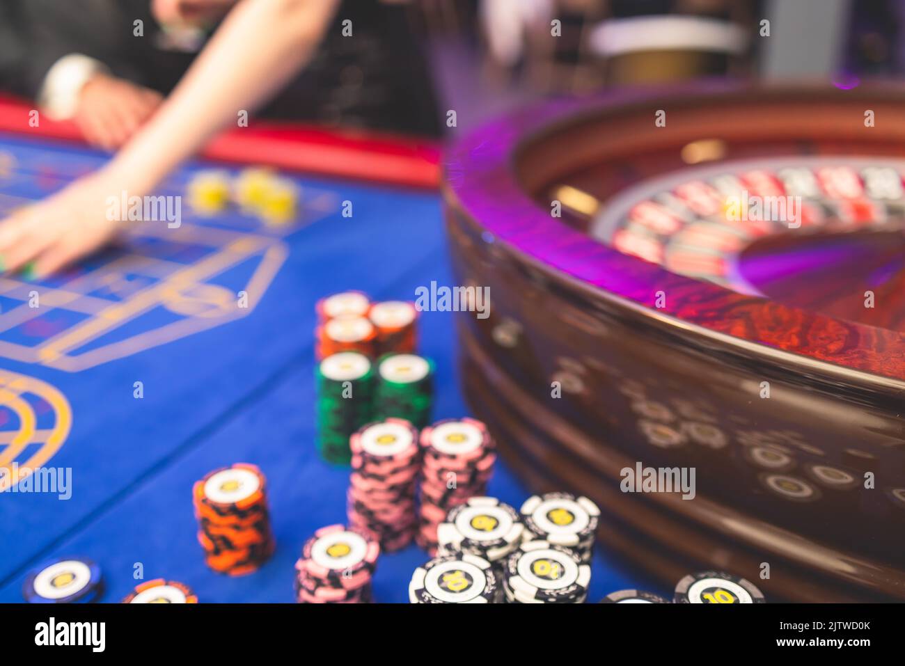 Vibrant casino table with roulette in motion, with casino chips, tokens ...