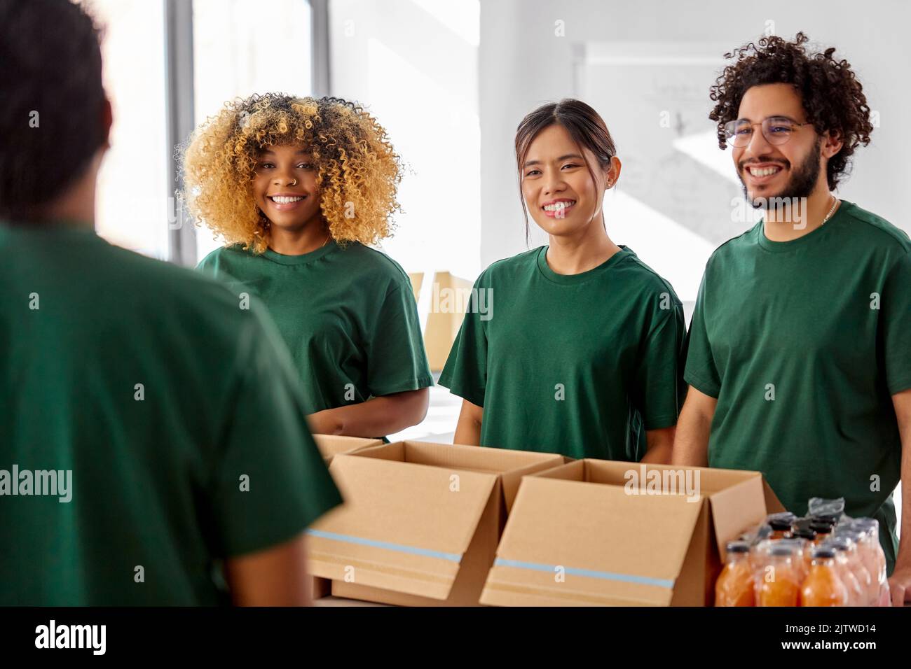 happy volunteers packing food in donation boxes Stock Photo - Alamy