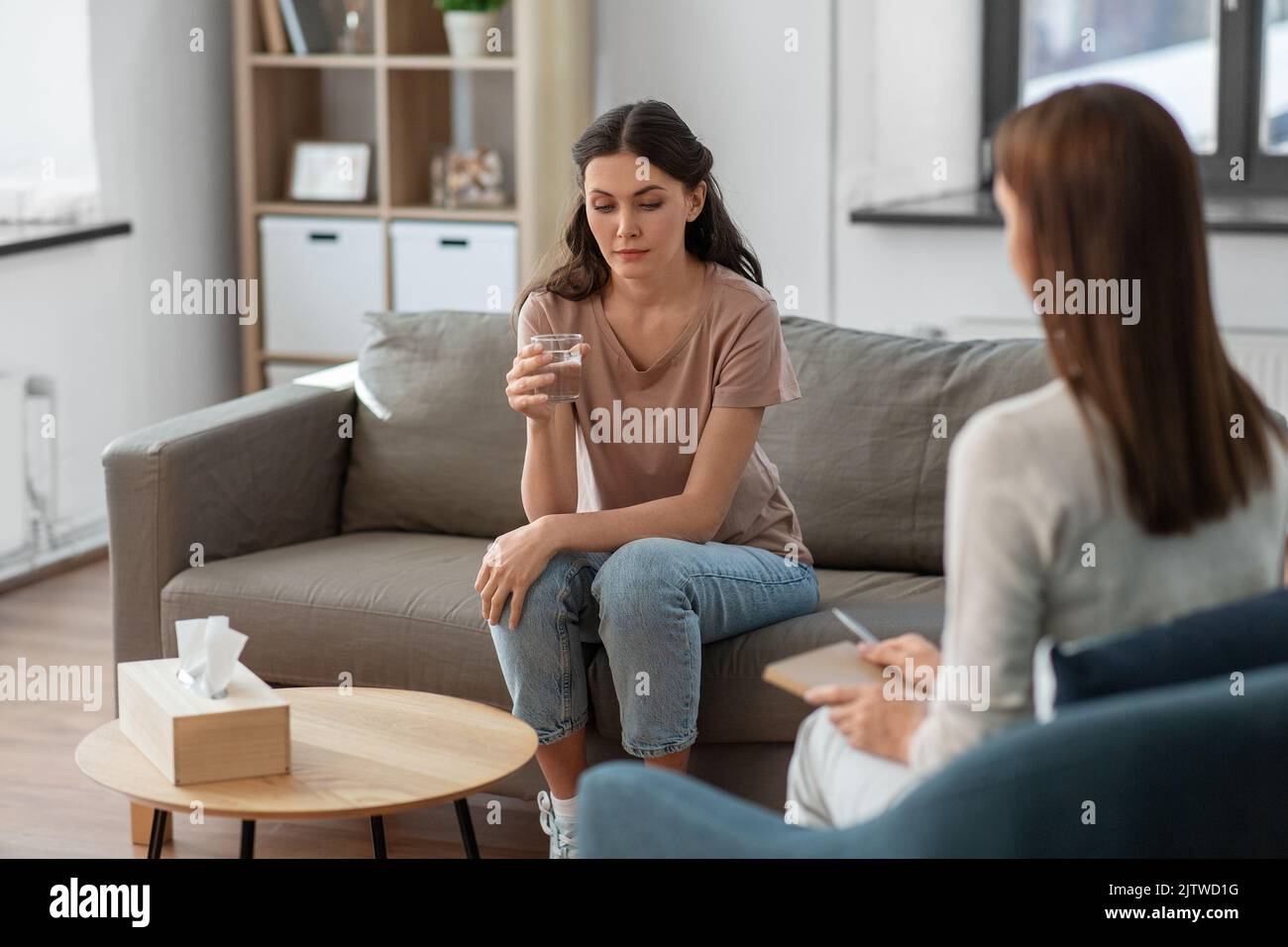 Female doctor drinking water hi-res stock photography and images - Alamy