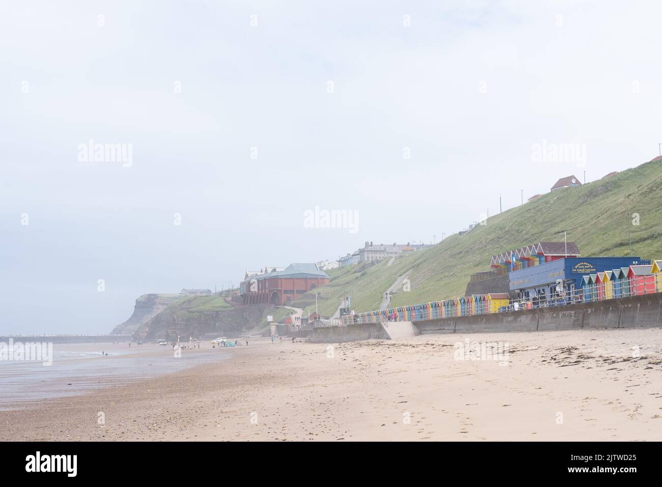 Whitby Beach with Beach huts and theatre in the background Stock Photo ...