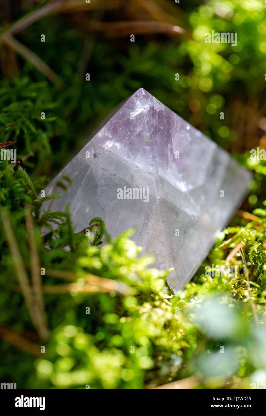 quartz crystal pyramid on moss in forest Stock Photo - Alamy