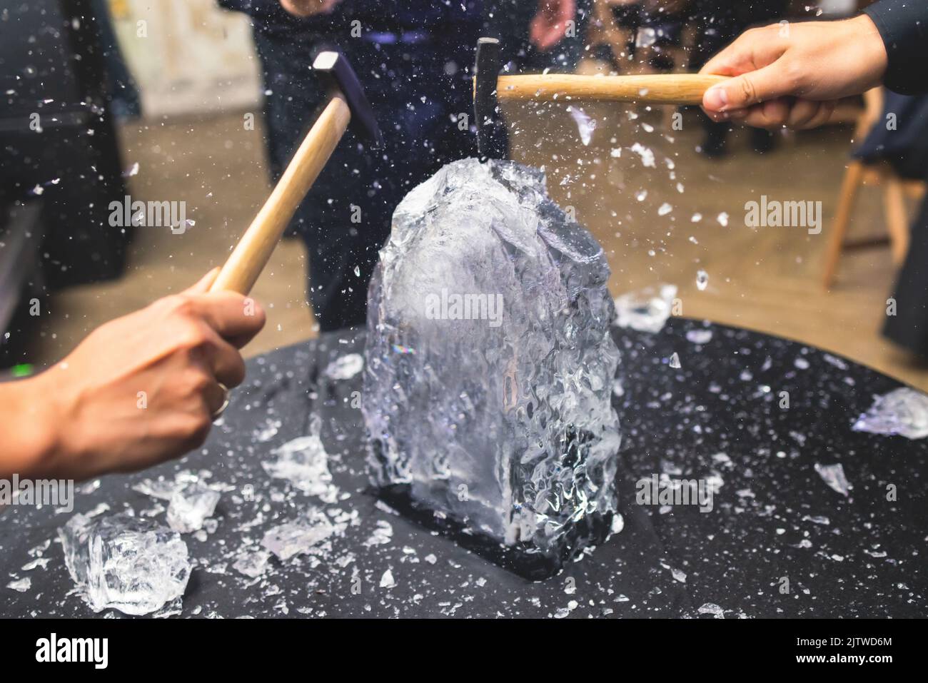 Process of breaking the ice with hammer and ice pick, group of people ...