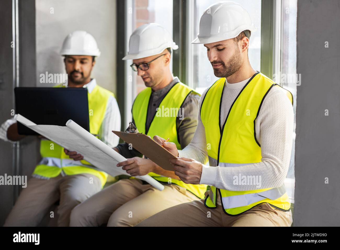 male architects in helmets working at office Stock Photo - Alamy