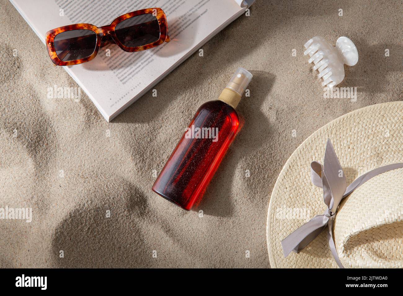 magazine, sunglasses and sunscreen on beach sand Stock Photo - Alamy