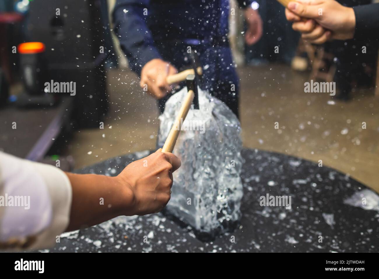 Process of breaking the ice with hammer and ice pick, group of people ...