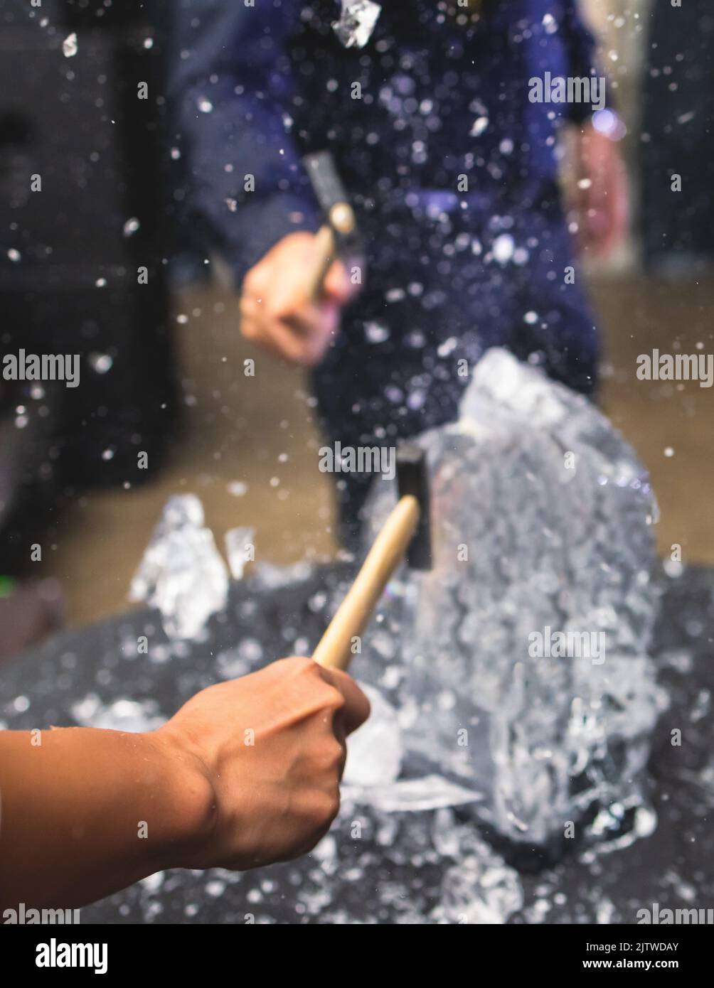 Process of breaking the ice with hammer and ice pick, group of people ...
