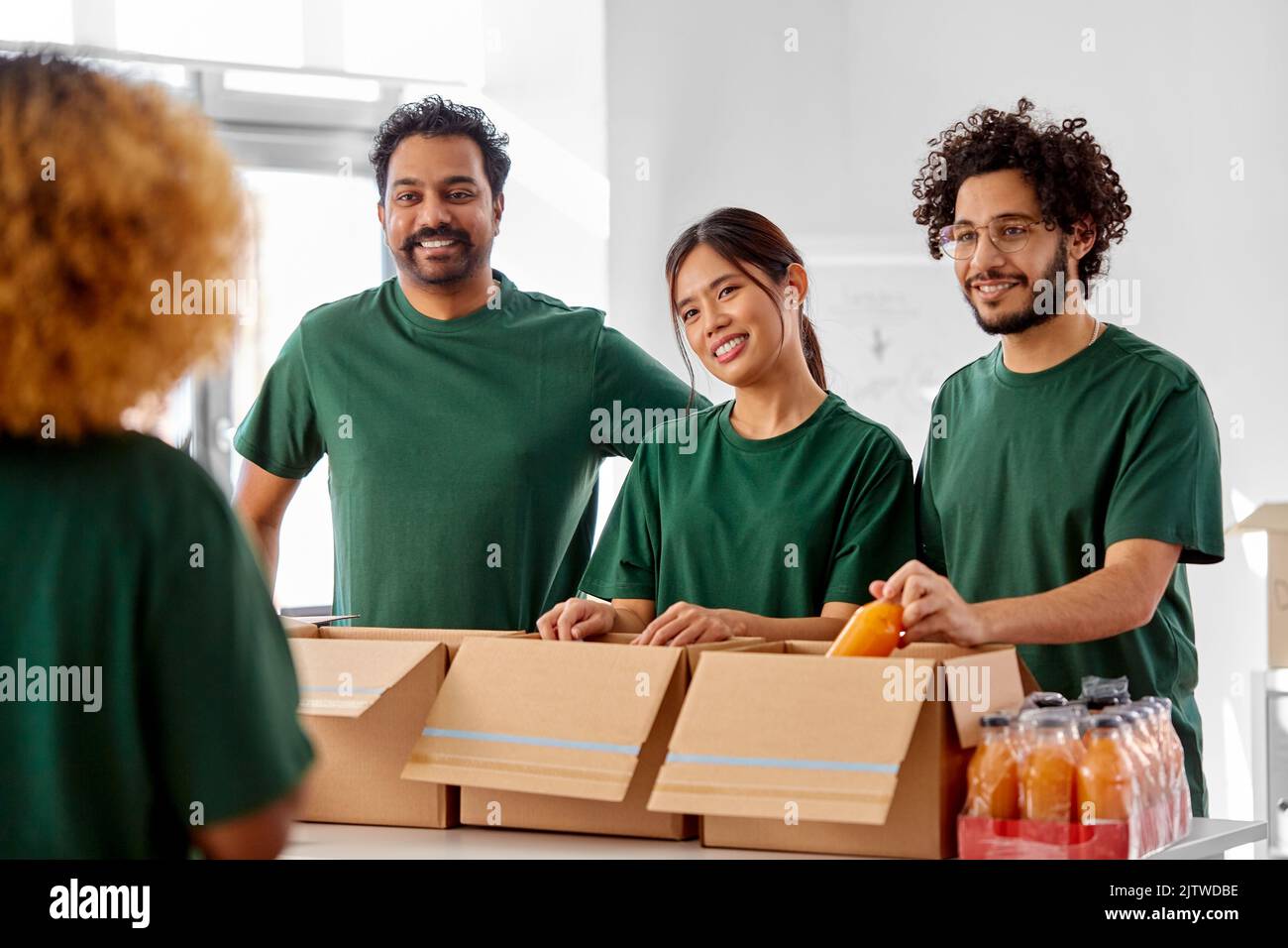 happy volunteers packing food in donation boxes Stock Photo - Alamy