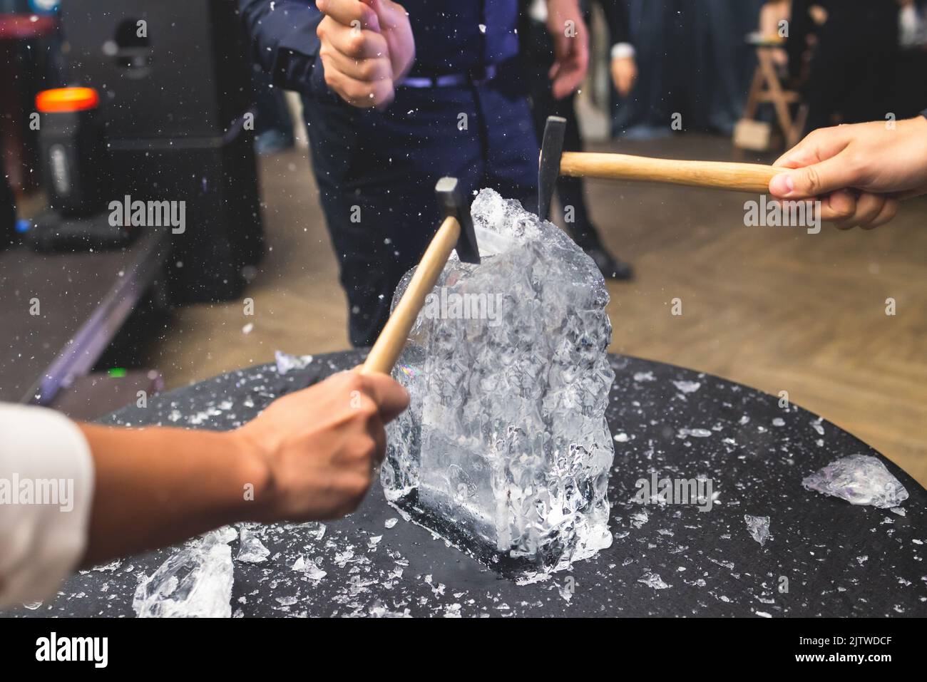 Process of breaking the ice with hammer and ice pick, group of people ...