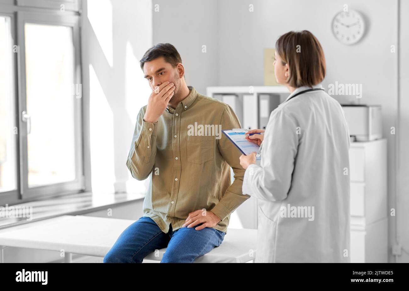 female doctor and coughing man at hospital Stock Photo - Alamy