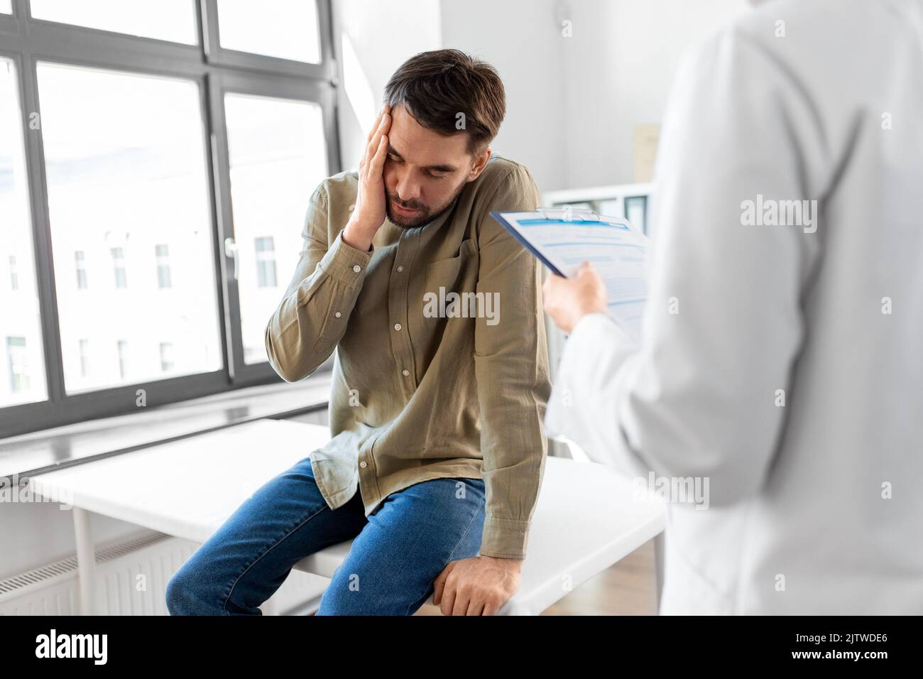 doctor and sad man with health problem at hospital Stock Photo - Alamy