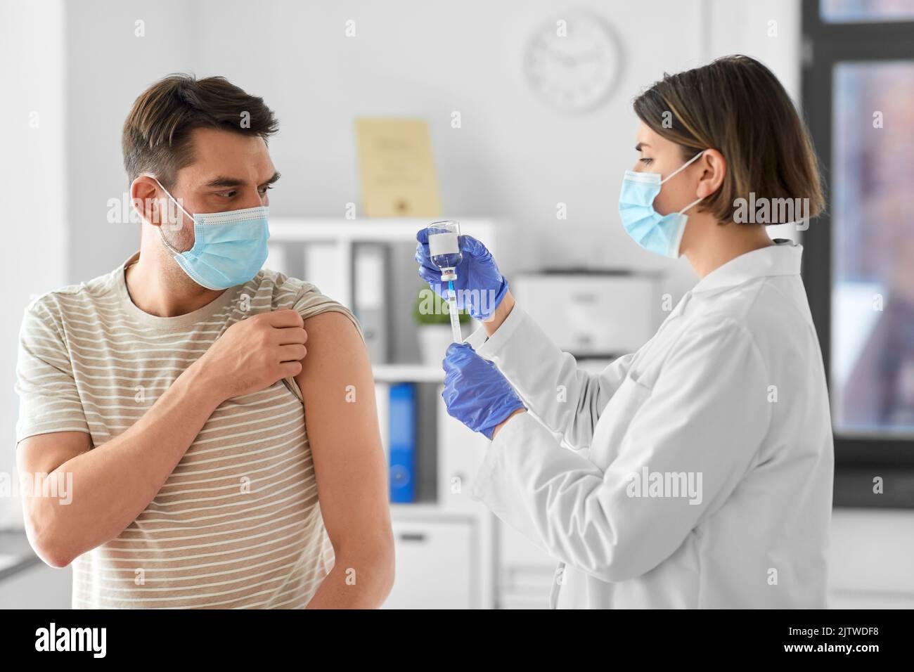 doctor with syringe vaccinating male patient Stock Photo - Alamy