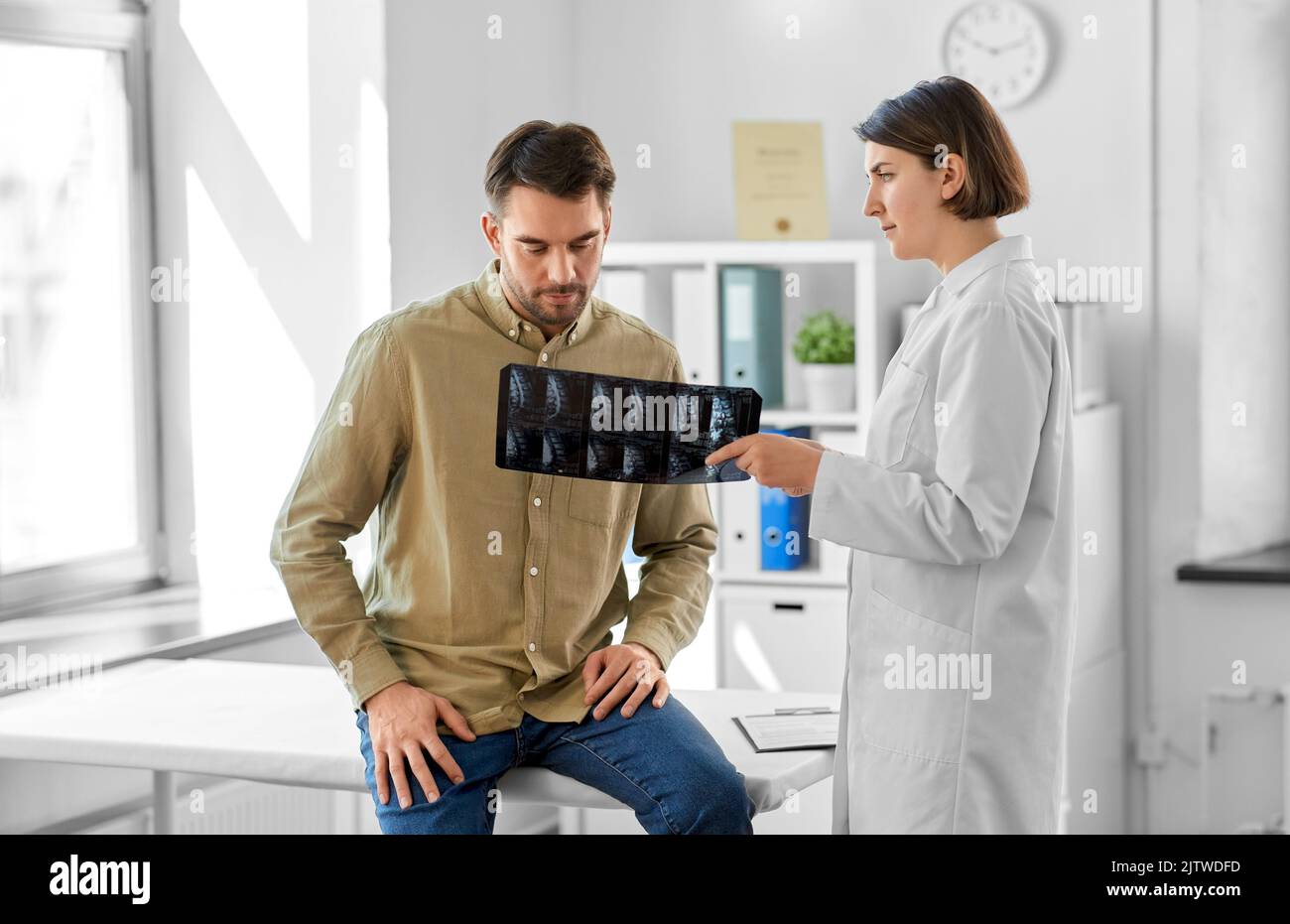 doctor showing x-ray to male patient at hospital Stock Photo - Alamy