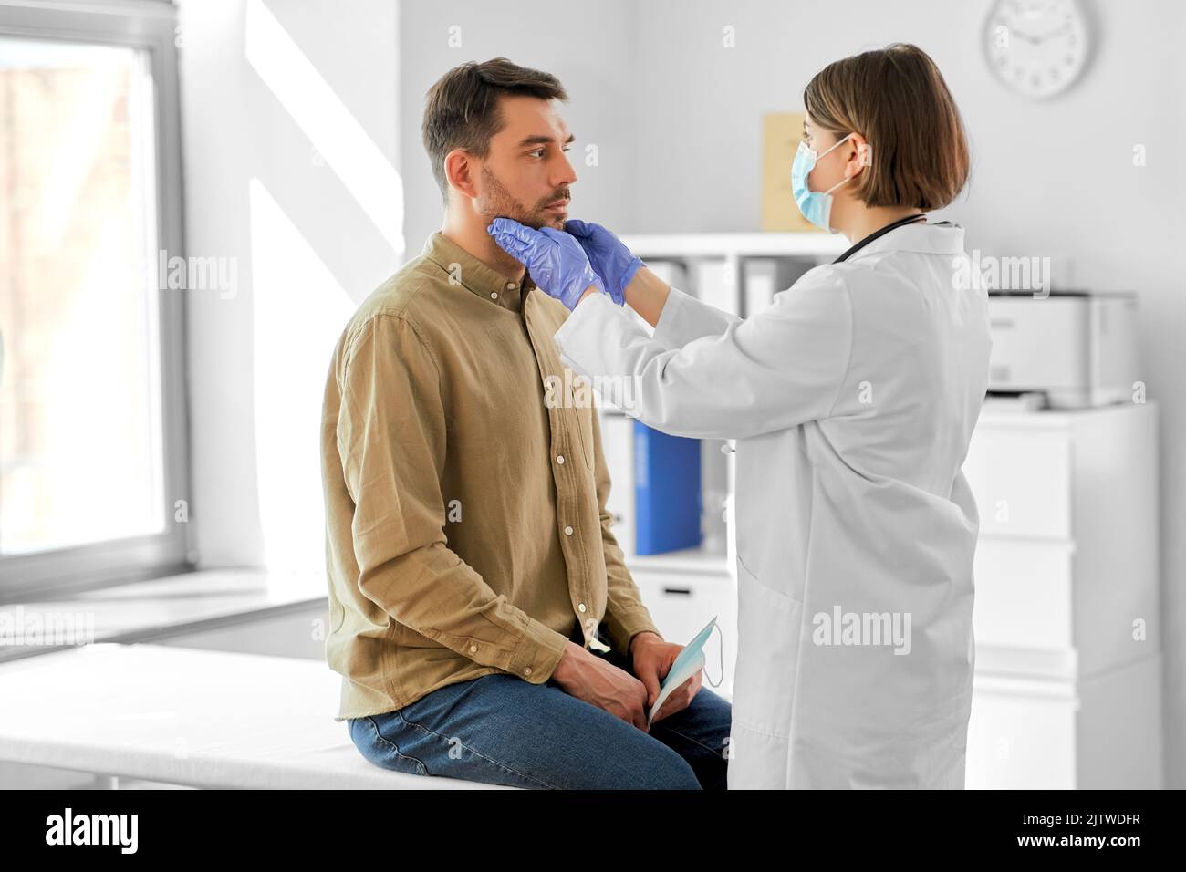 doctor checking lymph nodes of man at hospital Stock Photo - Alamy