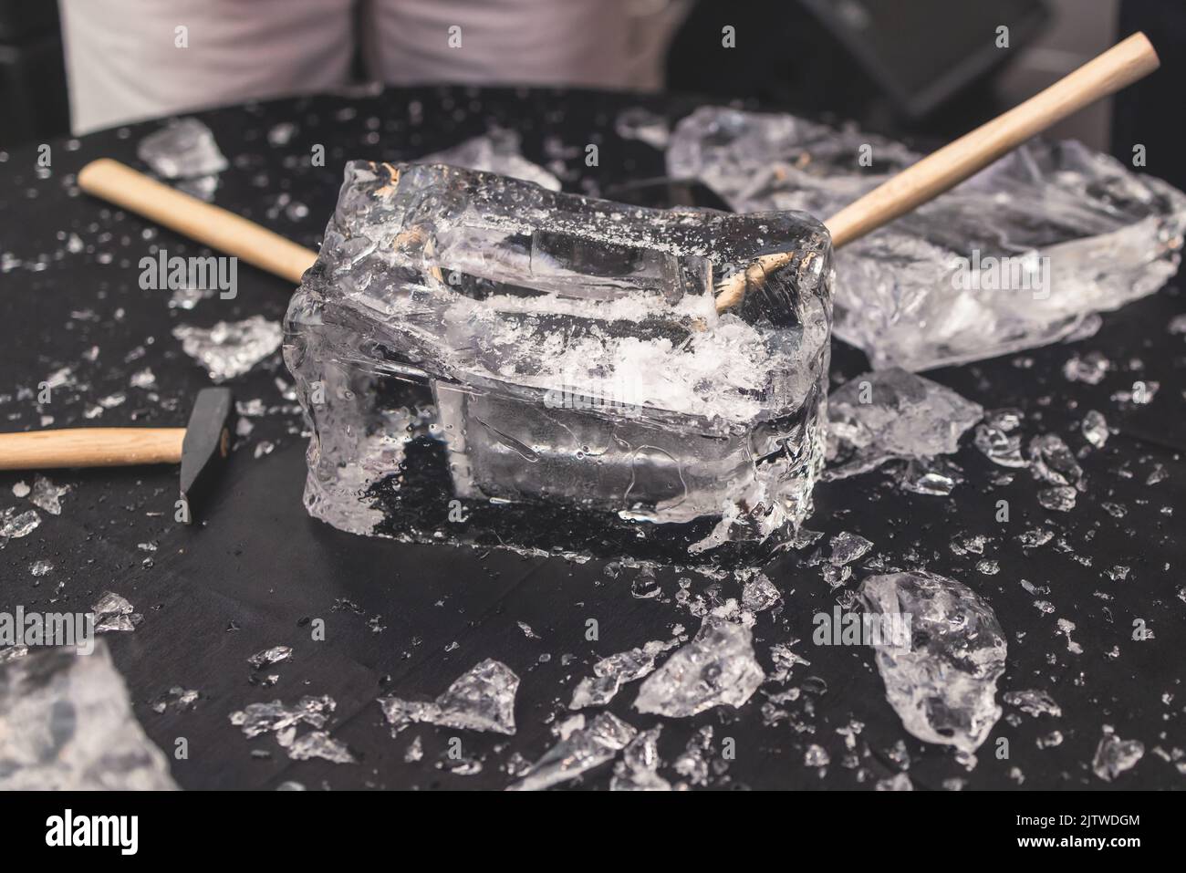 Process of breaking the ice with hammer and ice pick, group of people ...