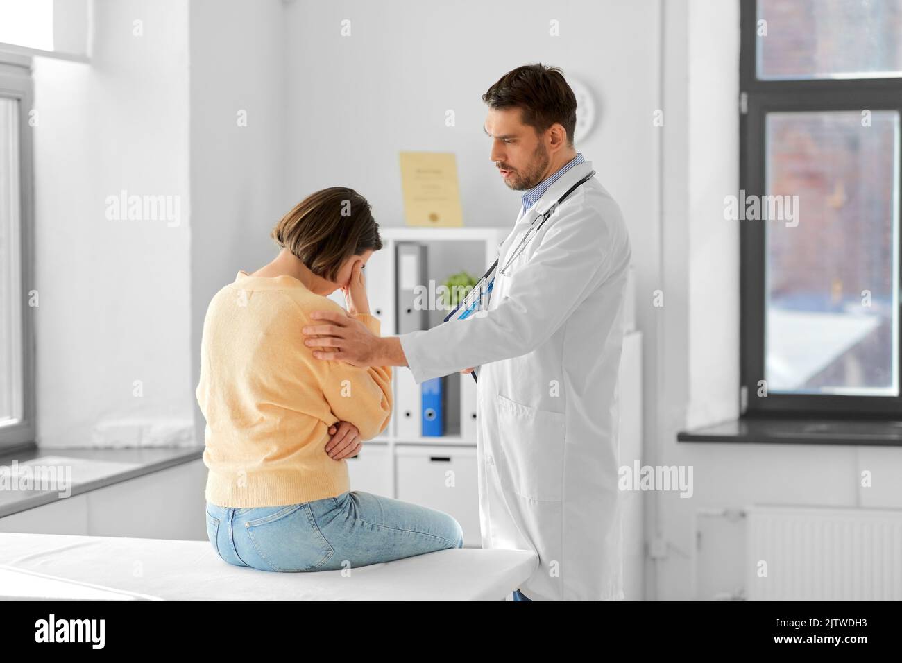 doctor comforting sad woman at hospital Stock Photo - Alamy