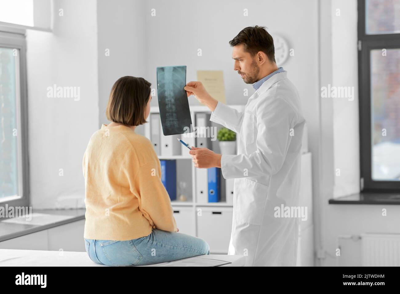 doctor showing x-ray to female patient at hospital Stock Photo - Alamy