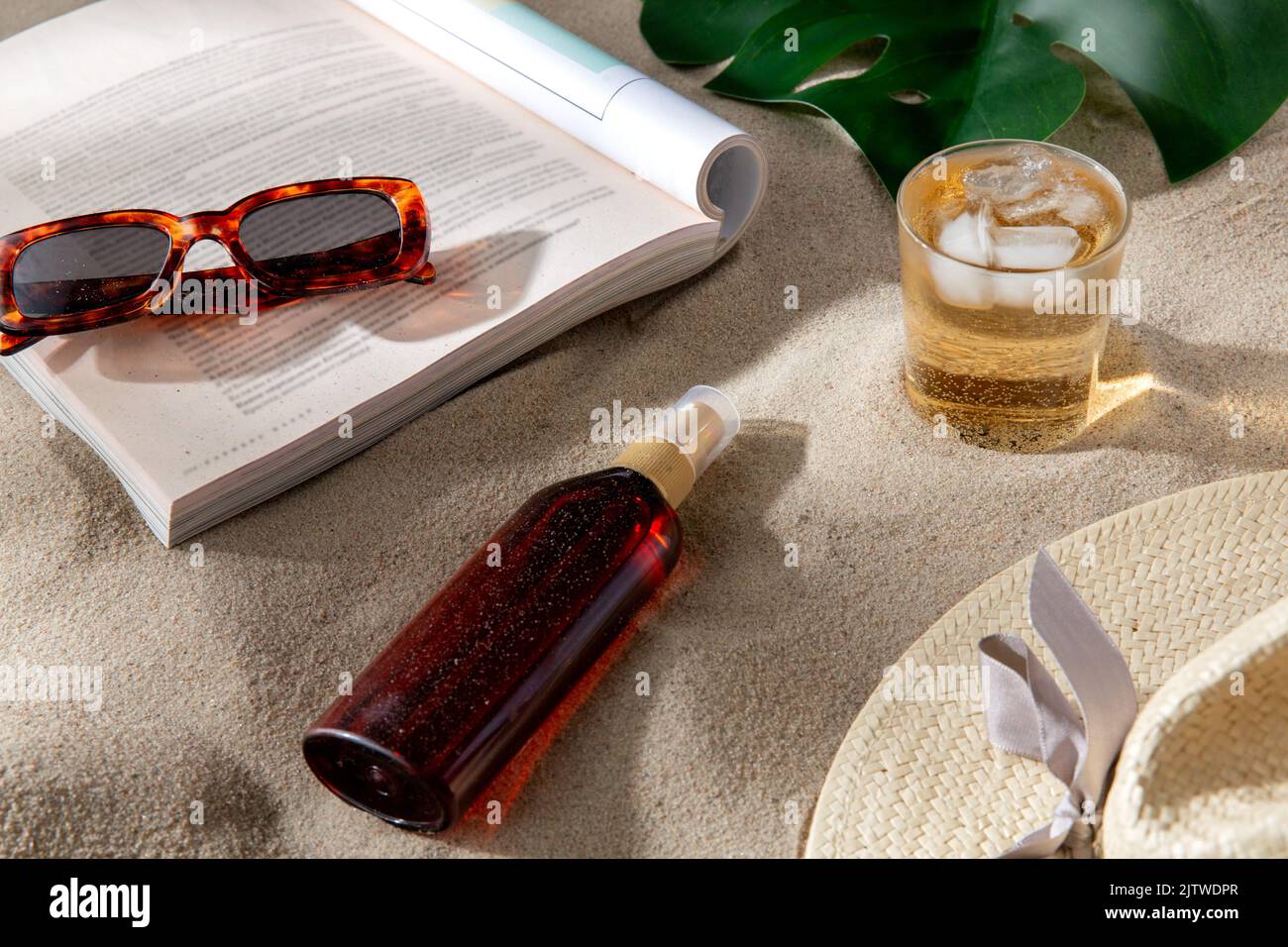 magazine, sunglasses and sunscreen on beach sand Stock Photo - Alamy