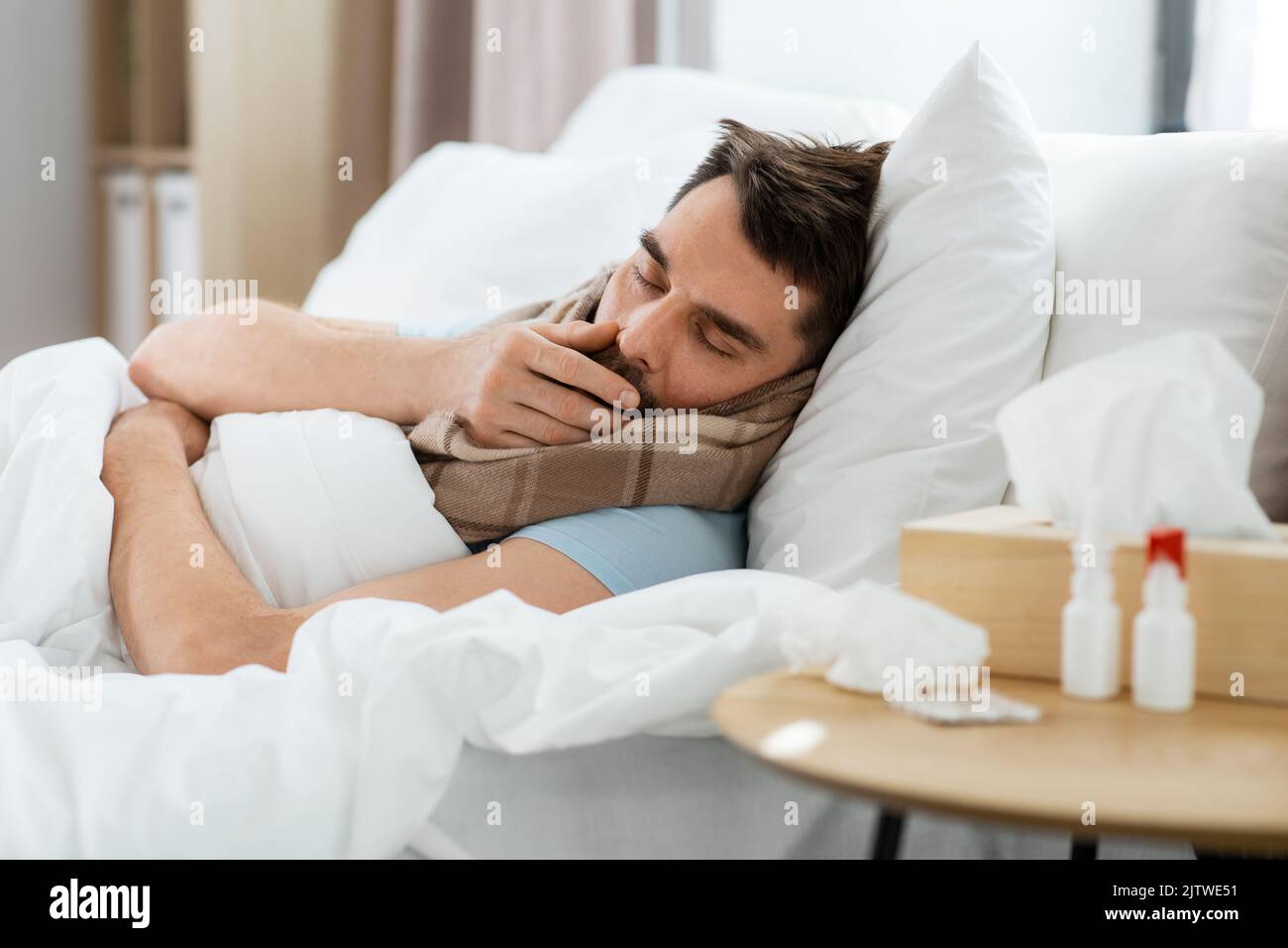 sick man coughing in bed at home Stock Photo - Alamy