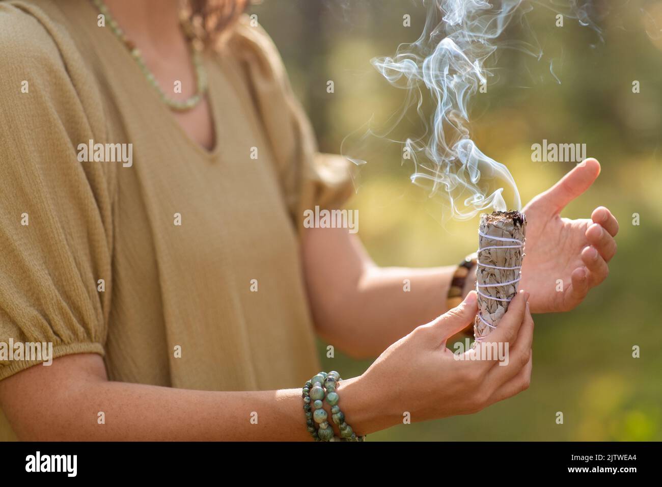 woman with sage performing magic ritual in forest Stock Photo - Alamy