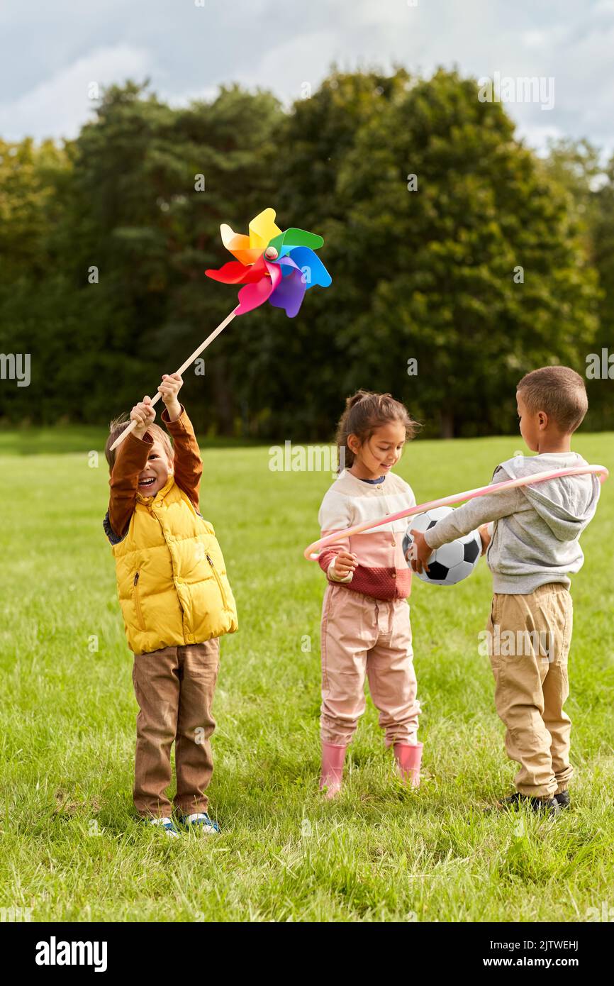 happy kids with pinwheel having fun at park Stock Photo - Alamy
