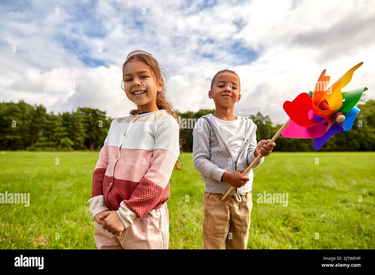 happy children playing with pinwheel at park Stock Photo - Alamy