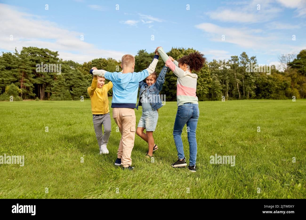happy children playing round dance at park Stock Photo - Alamy
