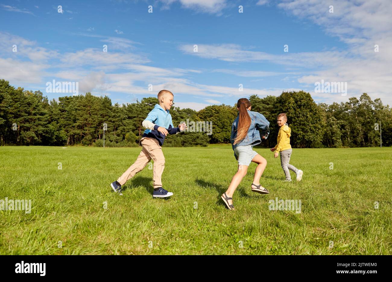 Happy group children playing chasing hi-res stock photography and ...