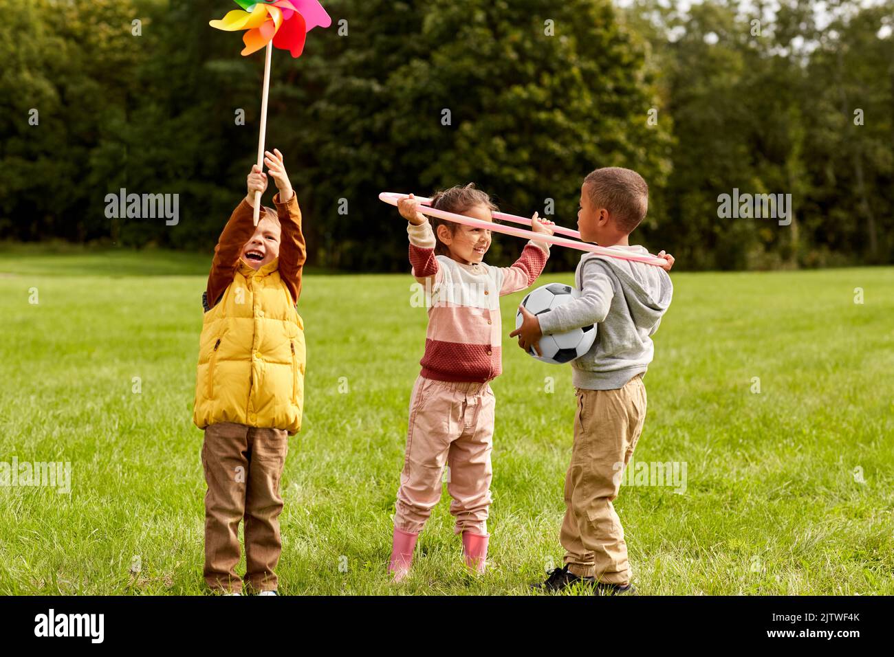 happy kids with pinwheel having fun at park Stock Photo - Alamy