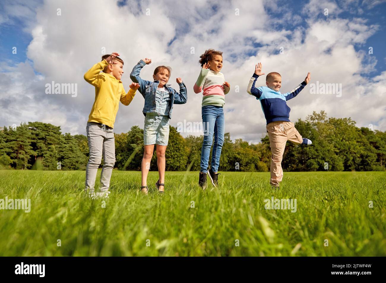 happy children jumping at park Stock Photo - Alamy