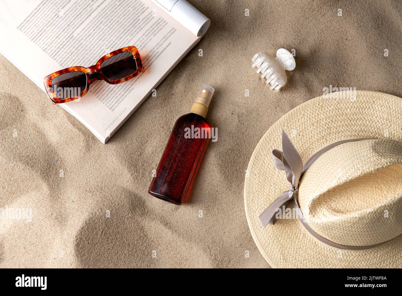 magazine, sunglasses and sunscreen on beach sand Stock Photo - Alamy