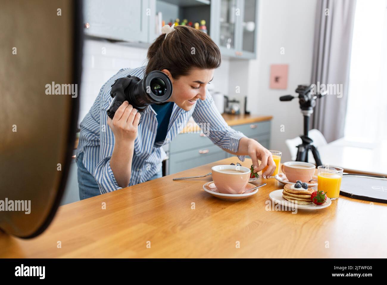 food photographer with camera working in kitchen Stock Photo - Alamy